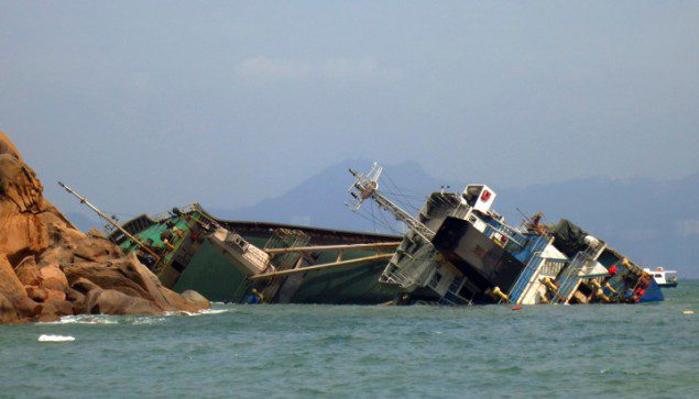 Cargo Ship On the Rocks Off Hong Kong [IMAGES]